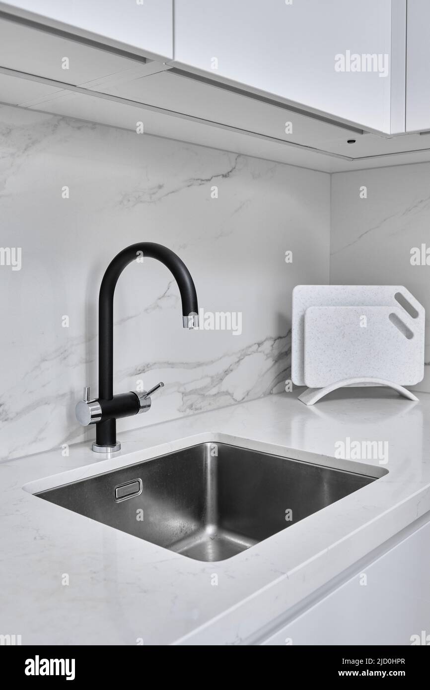 White kitchen with a small amount of decor Stock Photo - Alamy