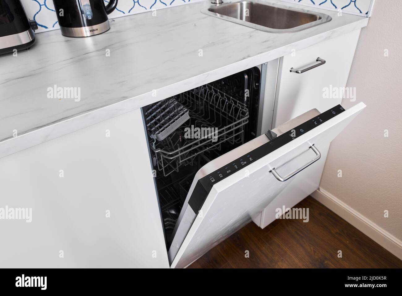 Photo of an open dishwasher in the kitchen Stock Photo - Alamy
