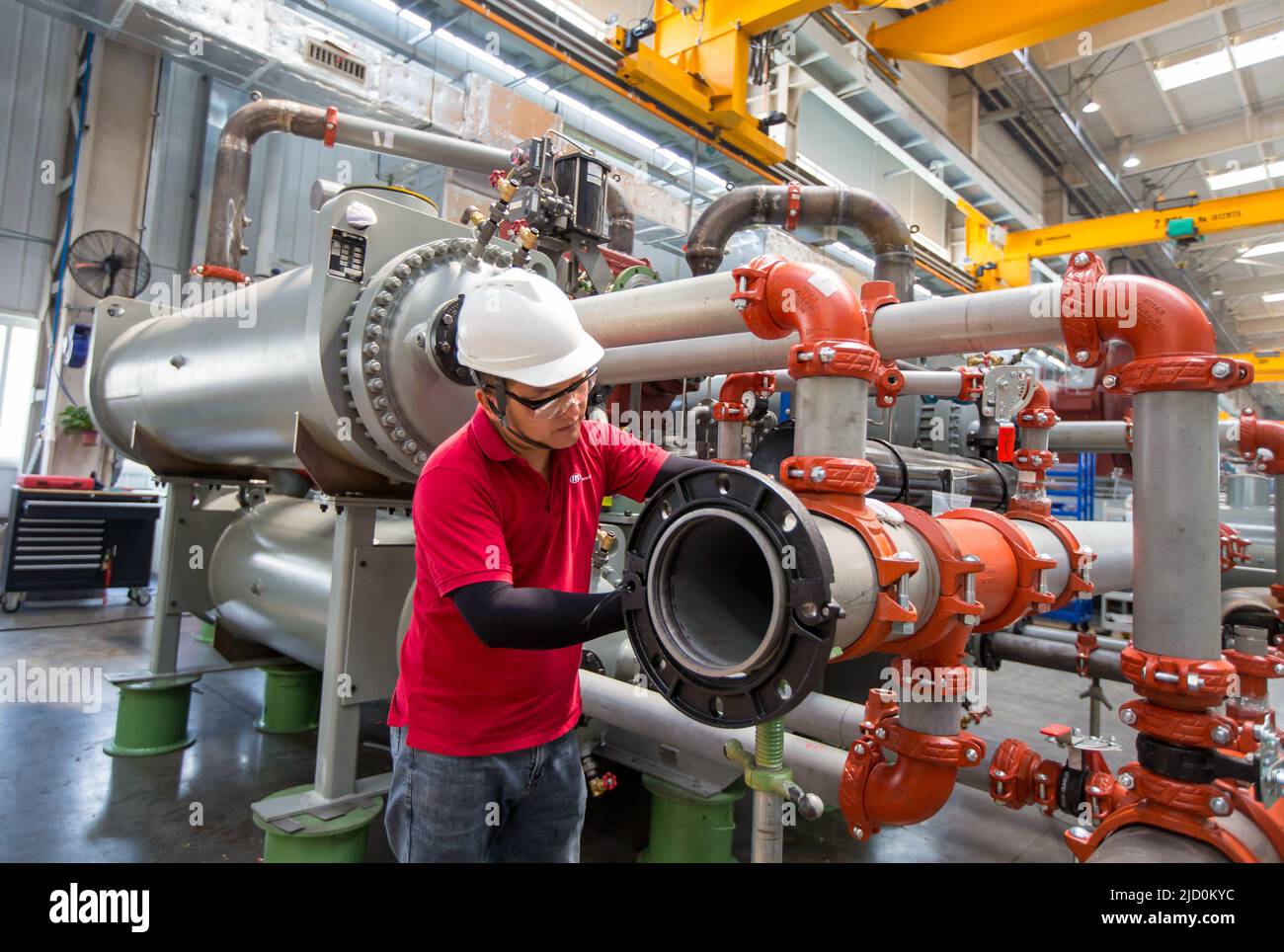 SUZHOU, CHINA - JUNE 16, 2022 - A worker produces air compressor ...