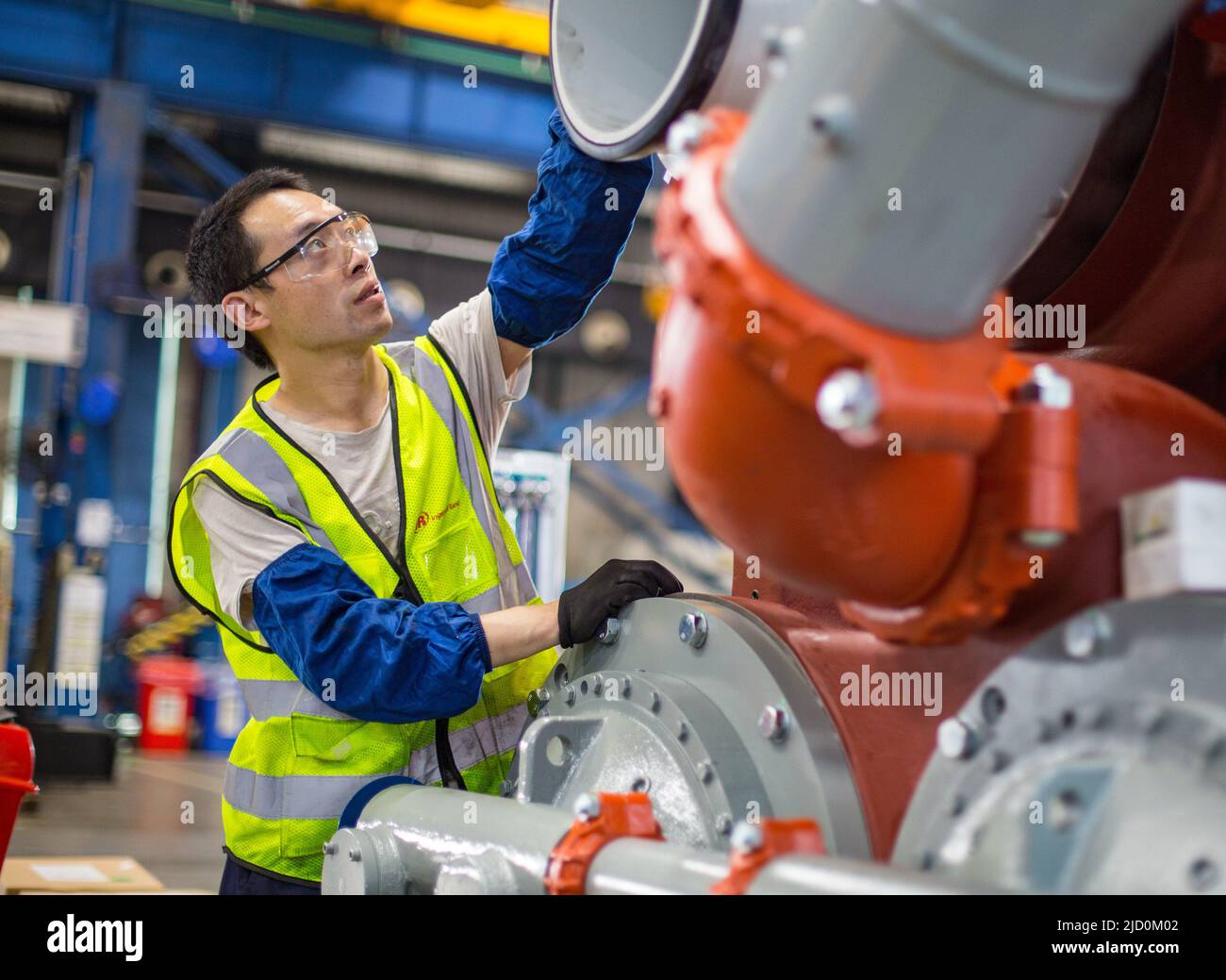 SUZHOU, CHINA - JUNE 16, 2022 - A worker produces air compressor ...
