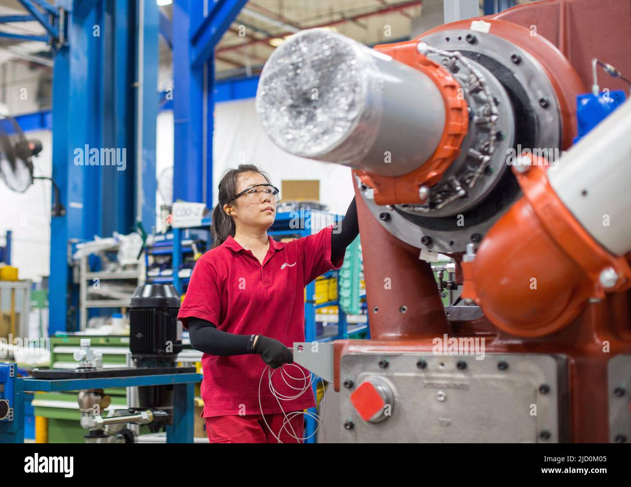 SUZHOU, CHINA - JUNE 16, 2022 - A worker produces air compressor ...
