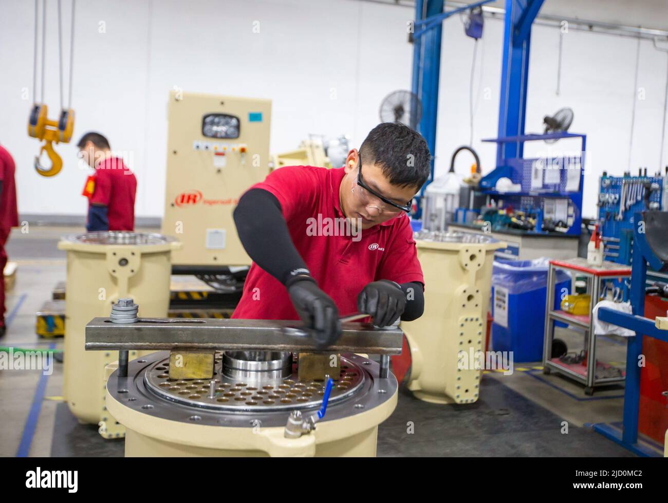 SUZHOU, CHINA - JUNE 16, 2022 - A worker produces air compressor ...
