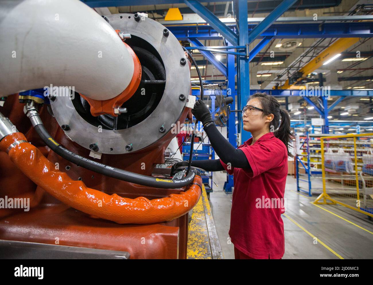 SUZHOU, CHINA - JUNE 16, 2022 - A worker produces air compressor ...