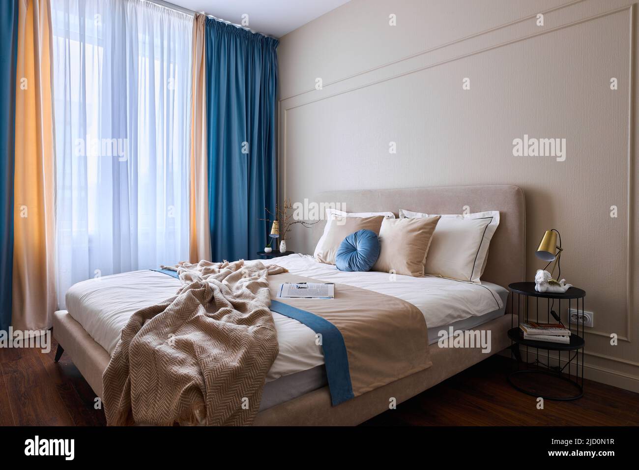 Beautiful cozy bed in an apartment for daily rent Stock Photo - Alamy