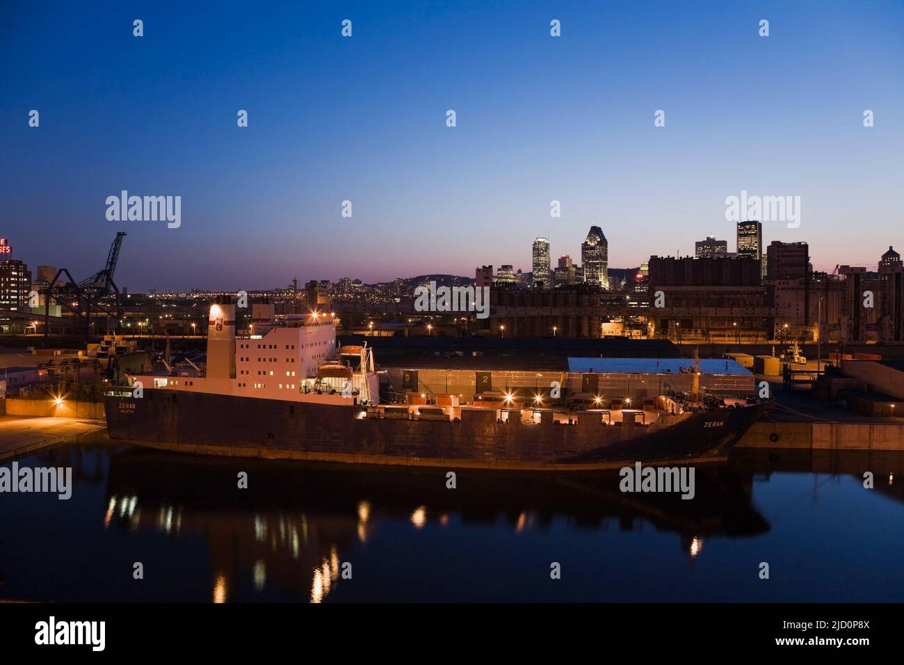 Cargo ship docked in the Port of Montreal and skyline at dusk, Quebec ...