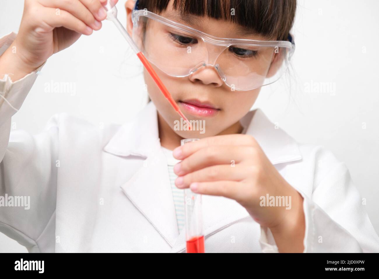 Little scientist. Smiling little girl learning classroom in school lab ...