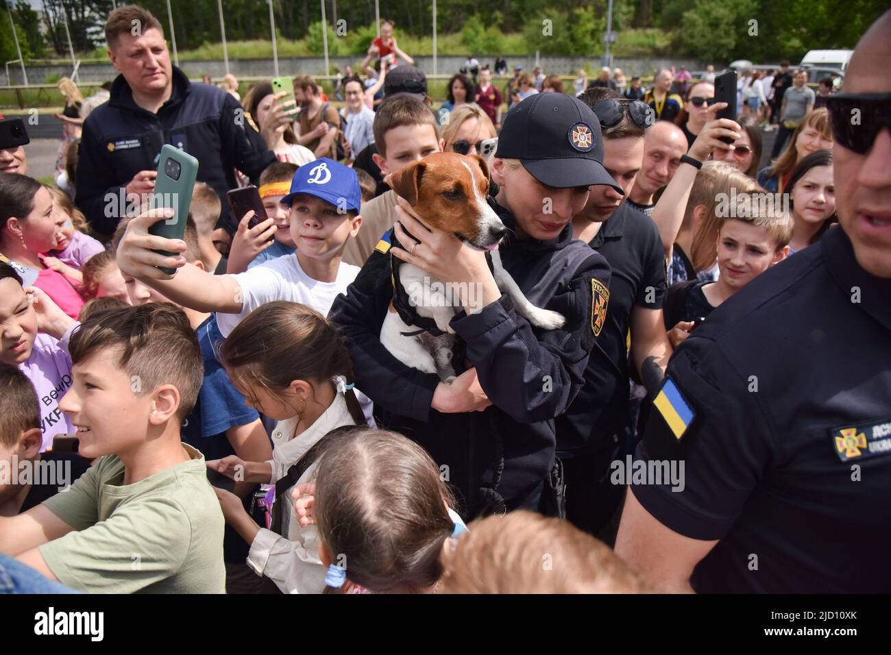Children are photographed with the famous sapper dog Patron during a ...
