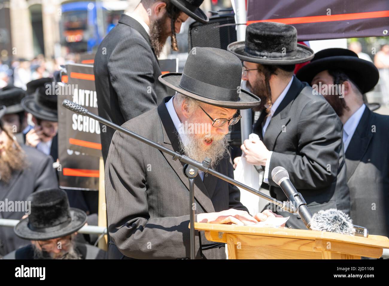 A rabbi leads prayers during the demonstration. Approximately 300 ...