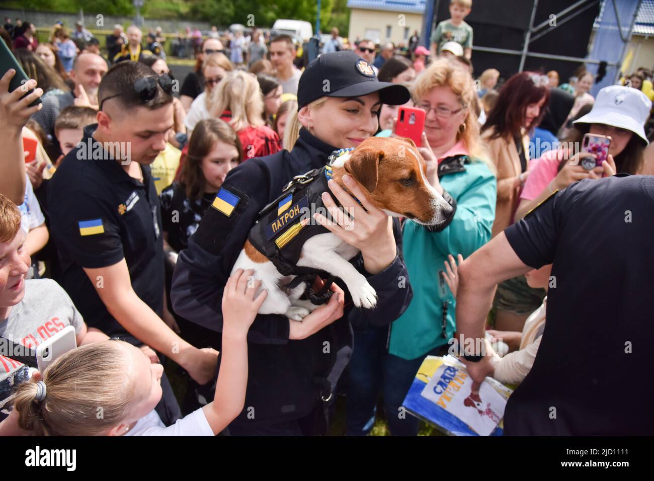 Children are photographed with the famous sapper dog Patron during a ...