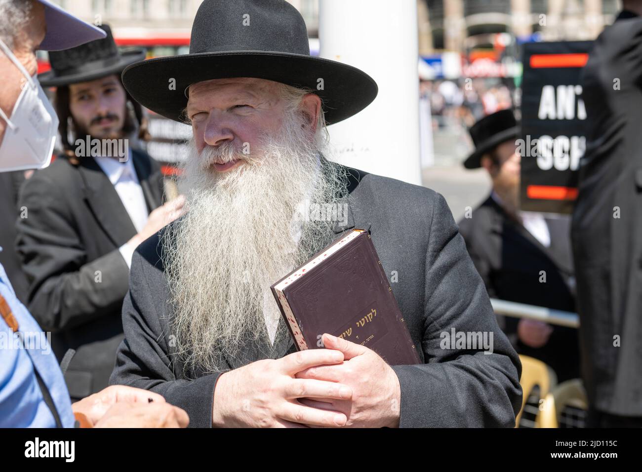 A rabbi speaks to members of the public about the anti schools bill ...