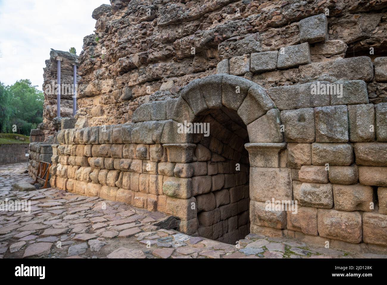 An arched stone pathway leading into the Roman Theatre of Merida ...