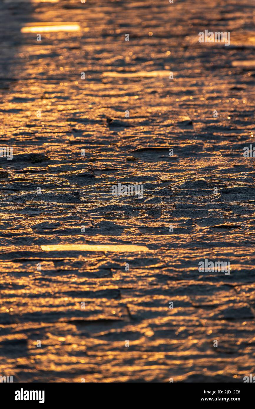 Stone pavement in the rays of the setting sun. Backround of Block ...