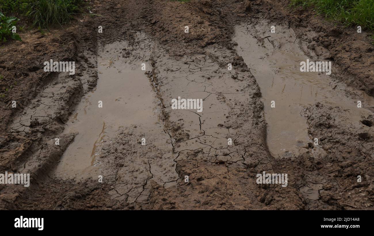 Muddy field with tire tracks and puddles. Dirty road with mud truck ...