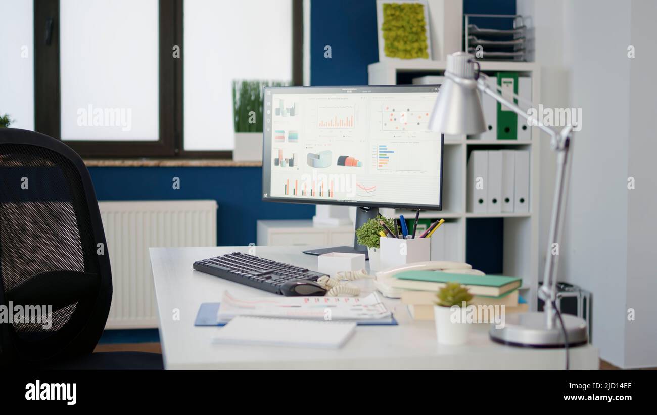 Computer screen with sales statistics on diagram at desk in empty ...