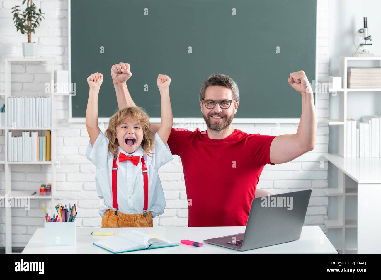 Excited school kid and teacher learning study in class. Education and ...