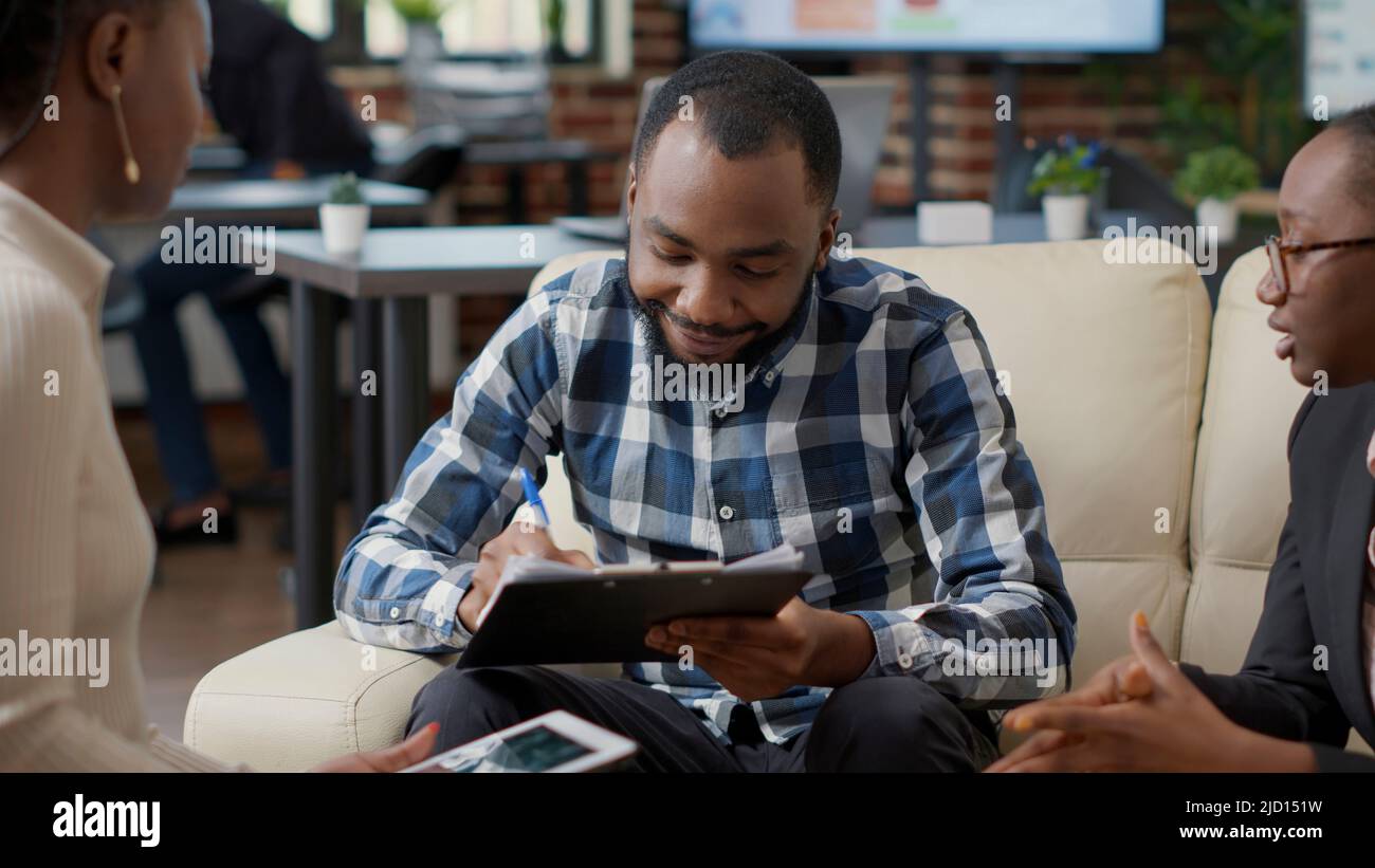Female employees congratulating man with successful ideas, shaking ...