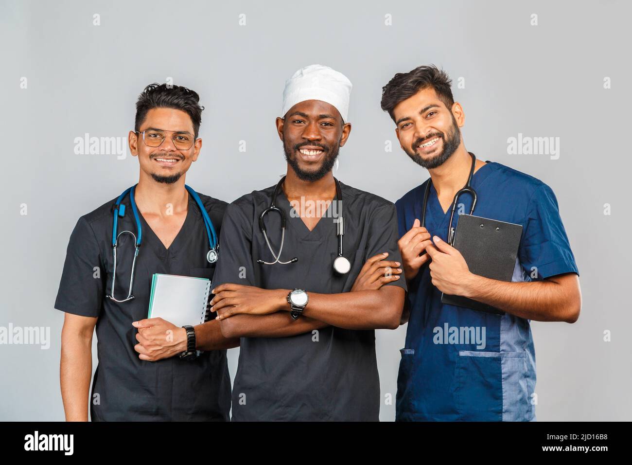 attractive medical team standing together over light gray background ...
