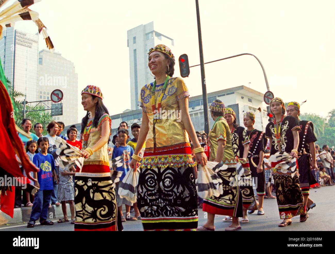 Young women wearing attire with Dayak motif and accessories ...