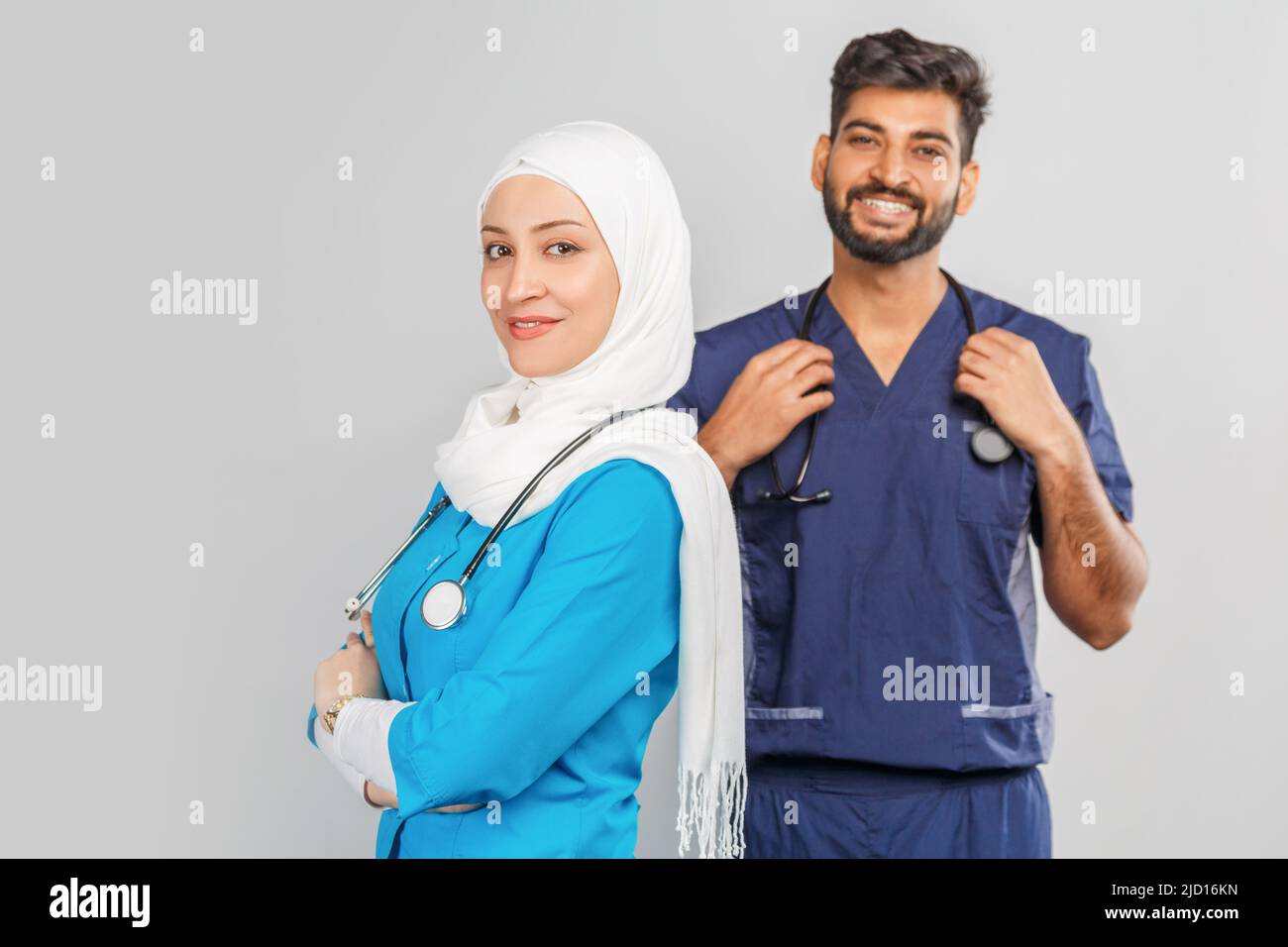 professional muslim doctor woman and indian assistant discuss tasks ...