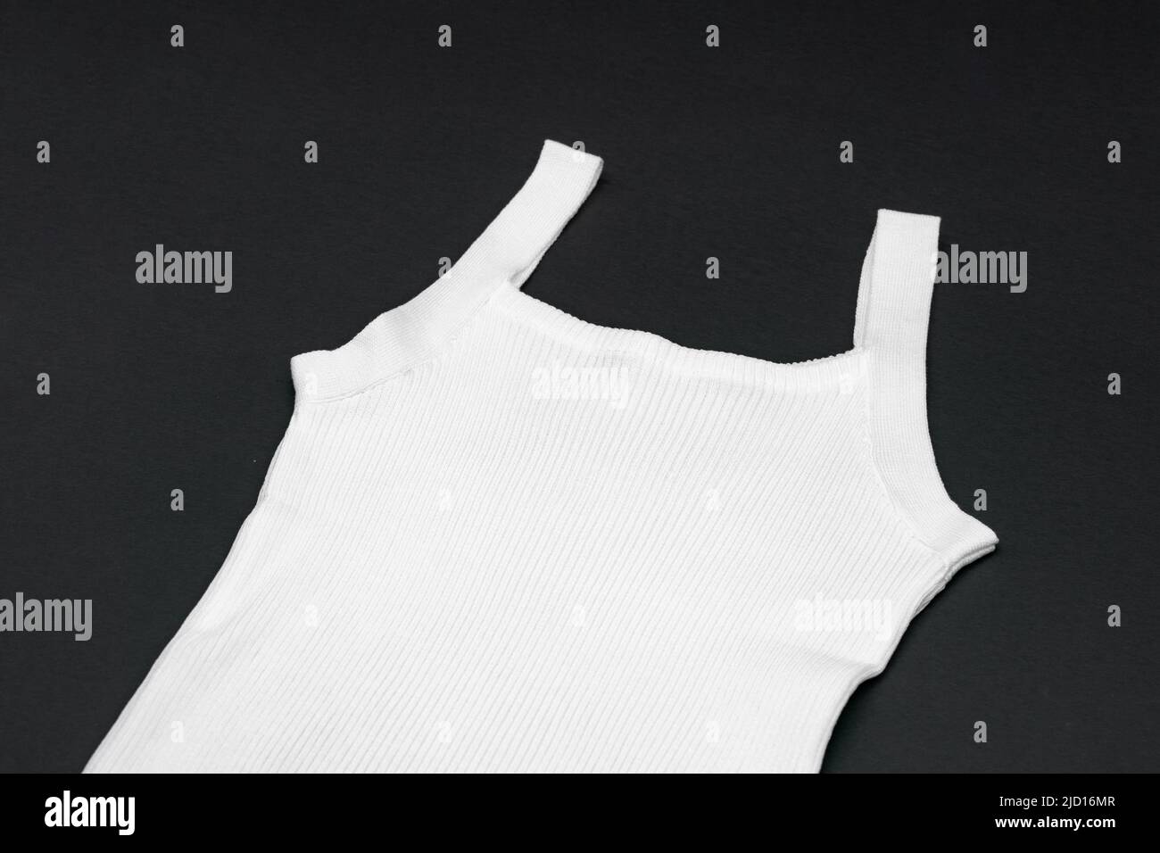 flat White knitwear vest shape on black background with studio light ...