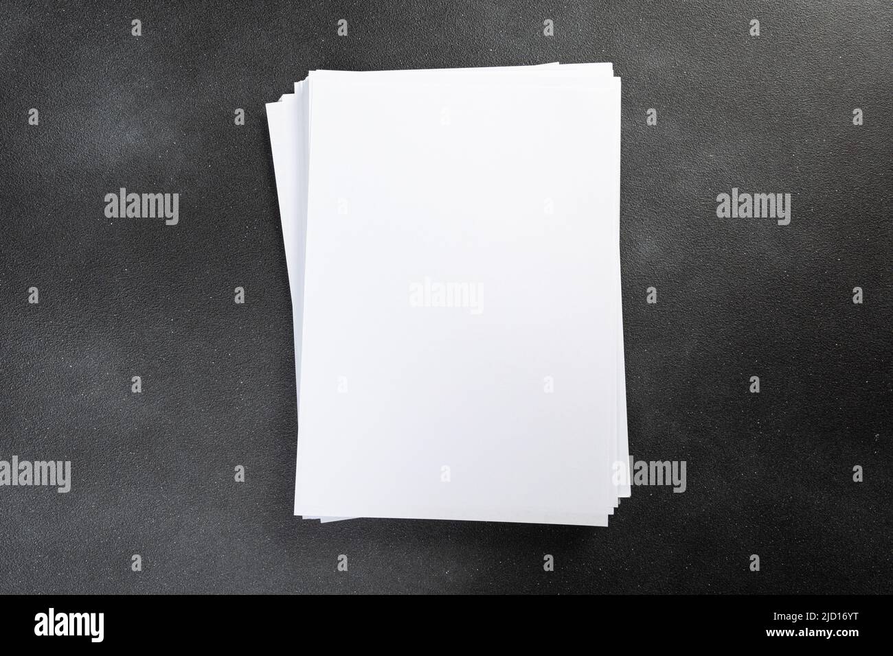 White business card sheet of paper a4 stack on a dark table. Clean ...