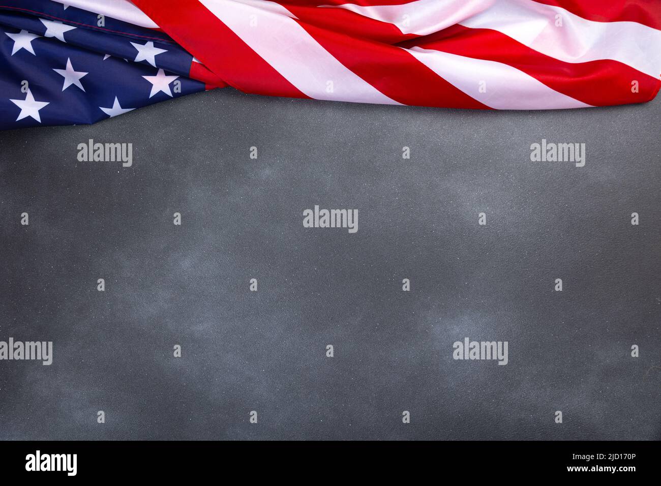 Close up of ruffled American flag on dark background. Satin texture ...