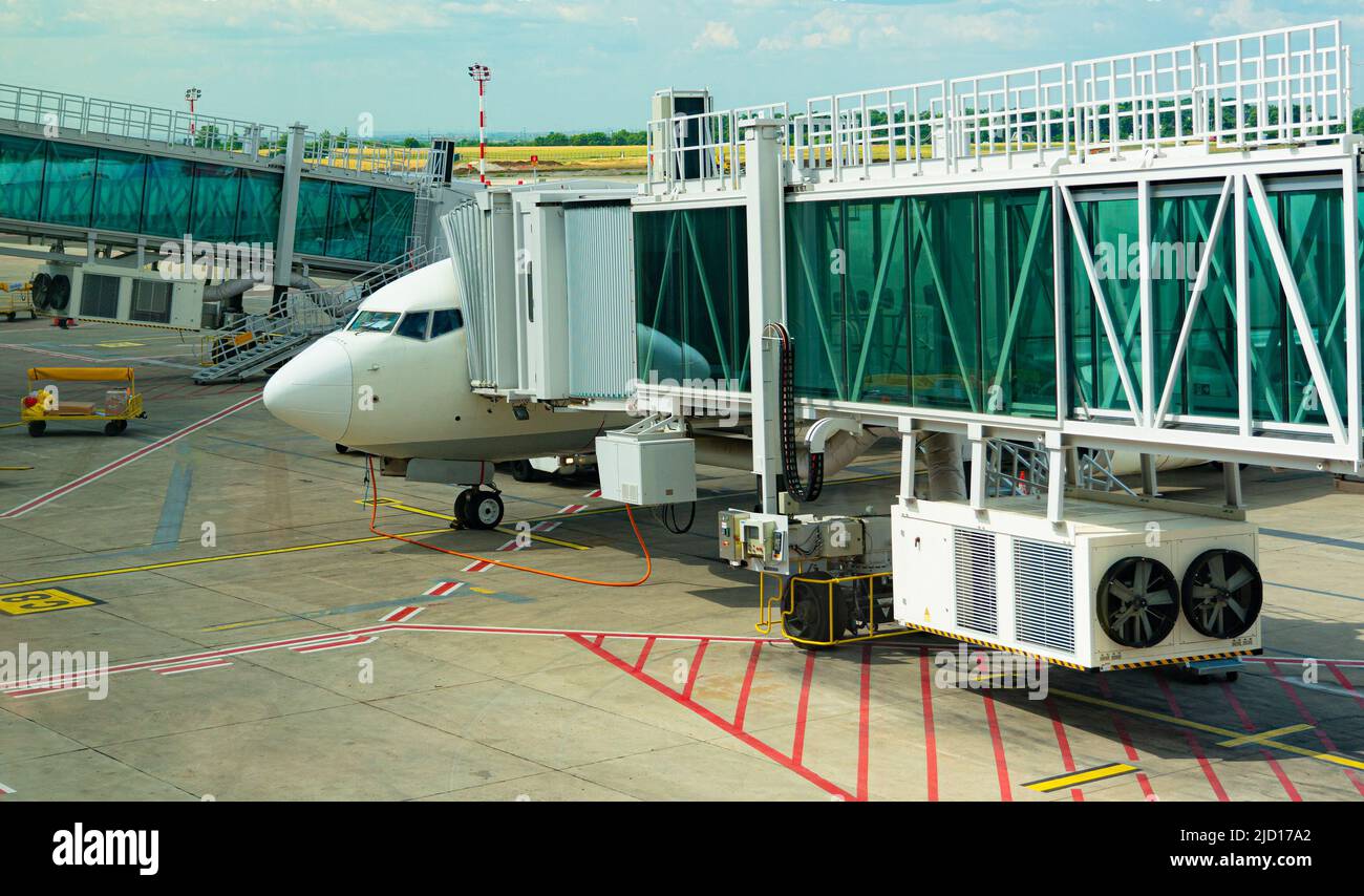 Airplane at the retractable gangway at the airport Stock Photo - Alamy