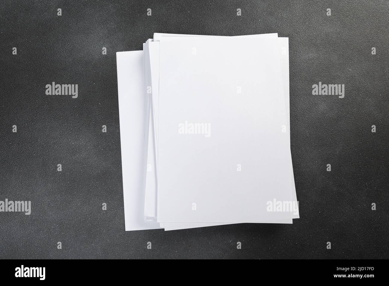 Blank flyer poster A4 paper isolated on dark gray to replace your ...