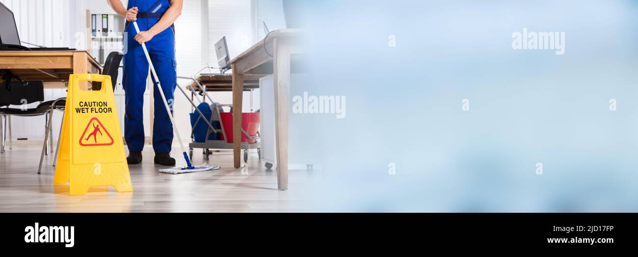 Janitor Cleaning Floor In Front Of Yellow Caution Wet Floor Sign Stock ...