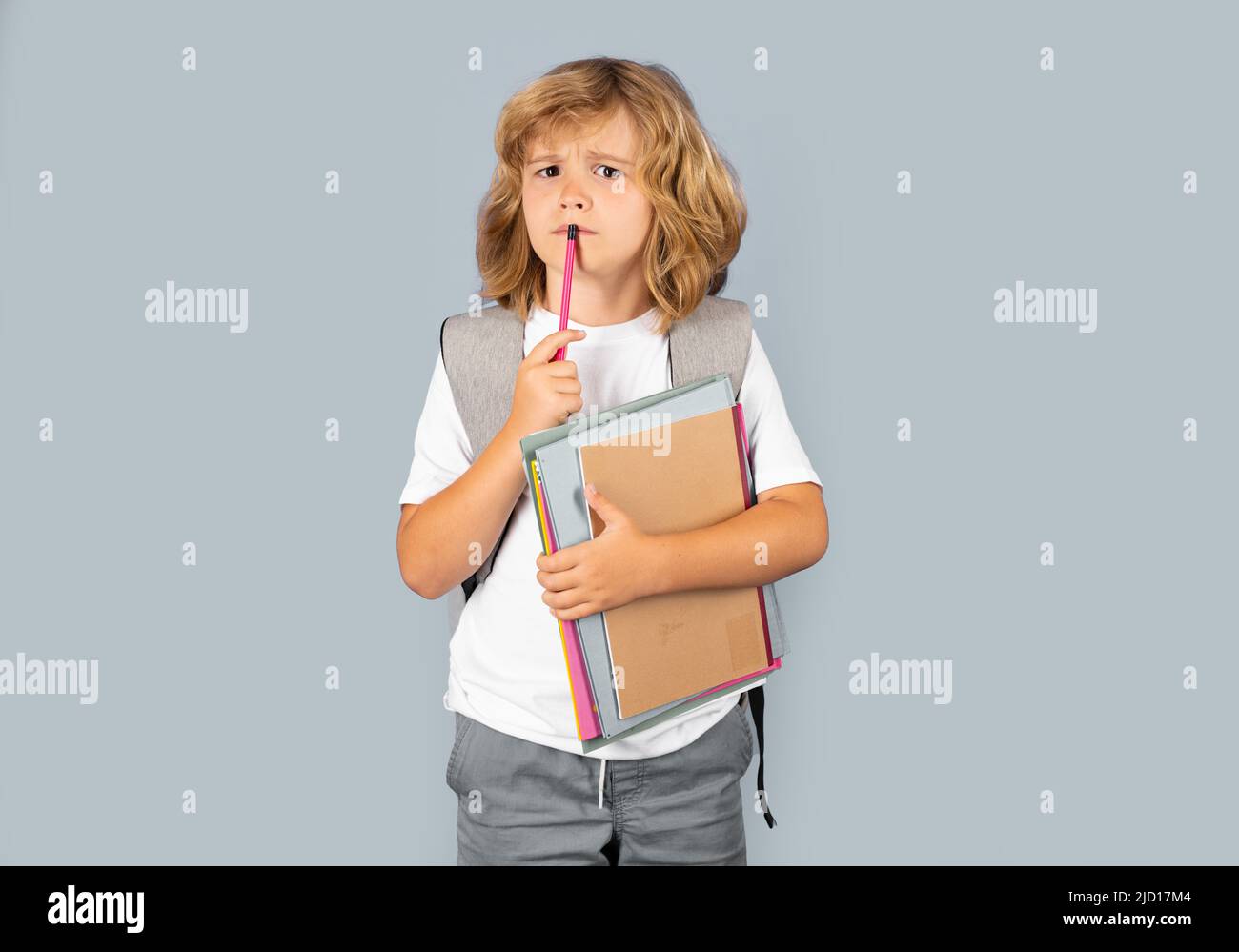Pupil student hold book on grey isolated background. School and ...