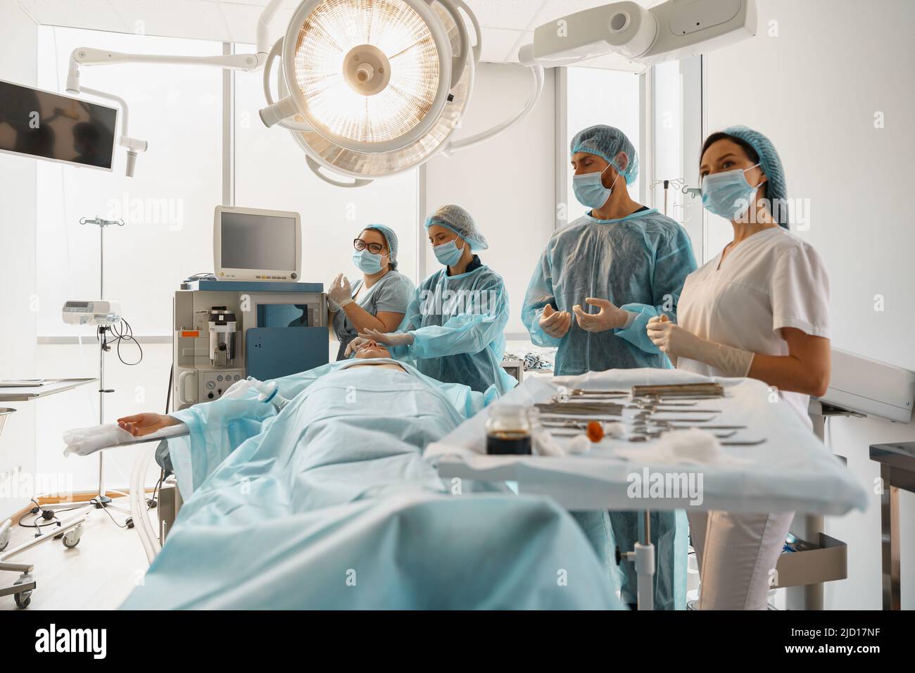 Concentrated professional surgical team working with a patient in an ...