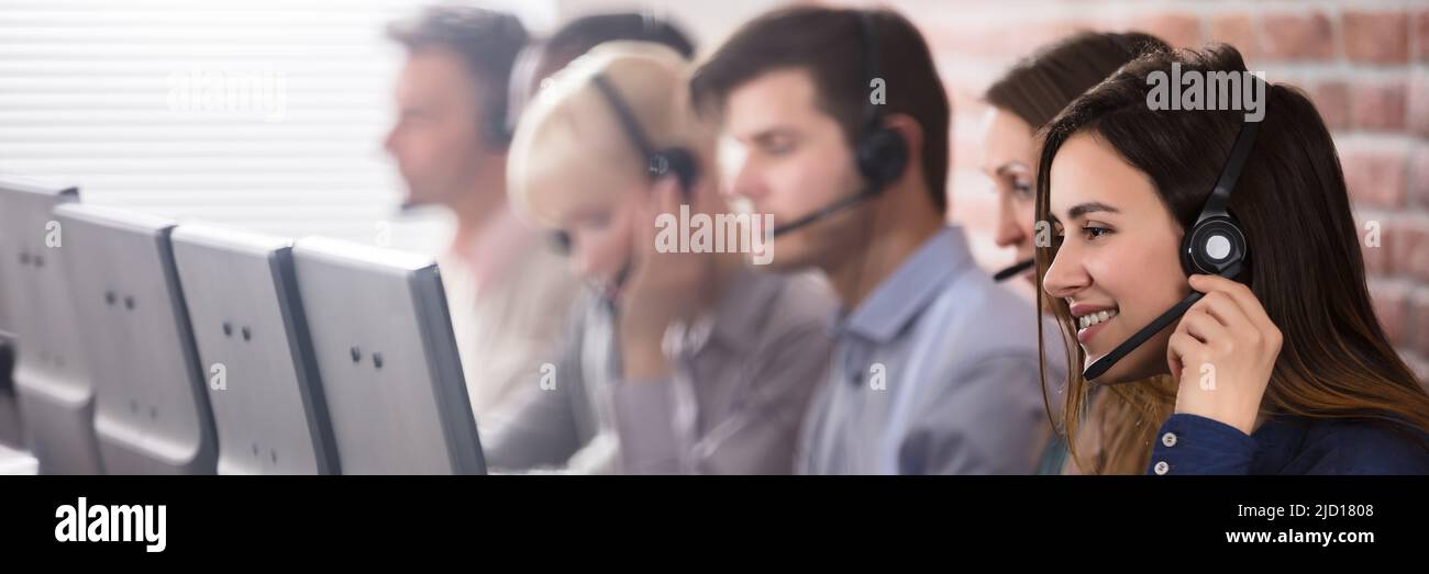 Positive Female Customer Services Agent With Headset Working In A Call ...