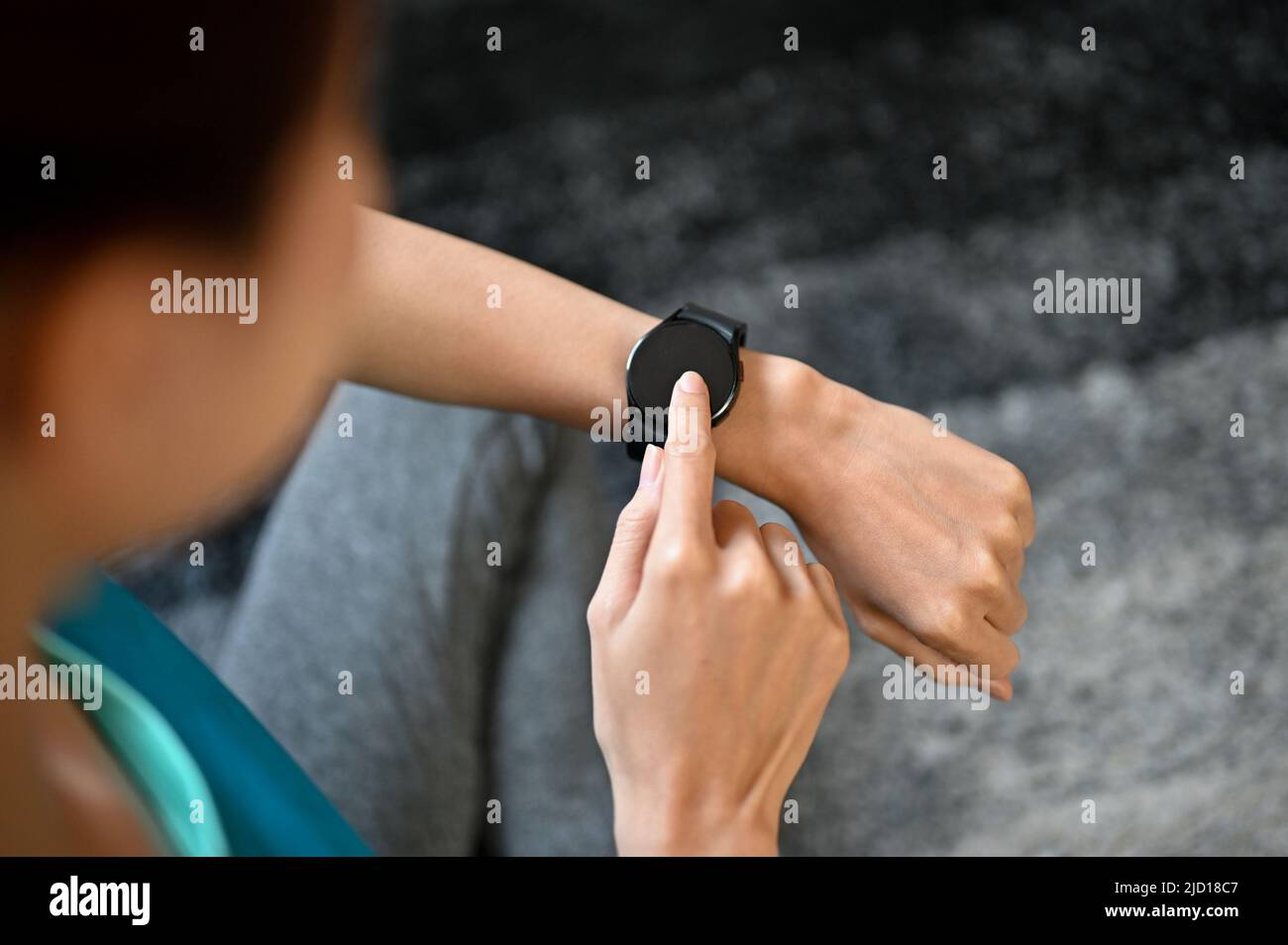 Female checking her heart rate and pulse on her modern smartwatch after ...
