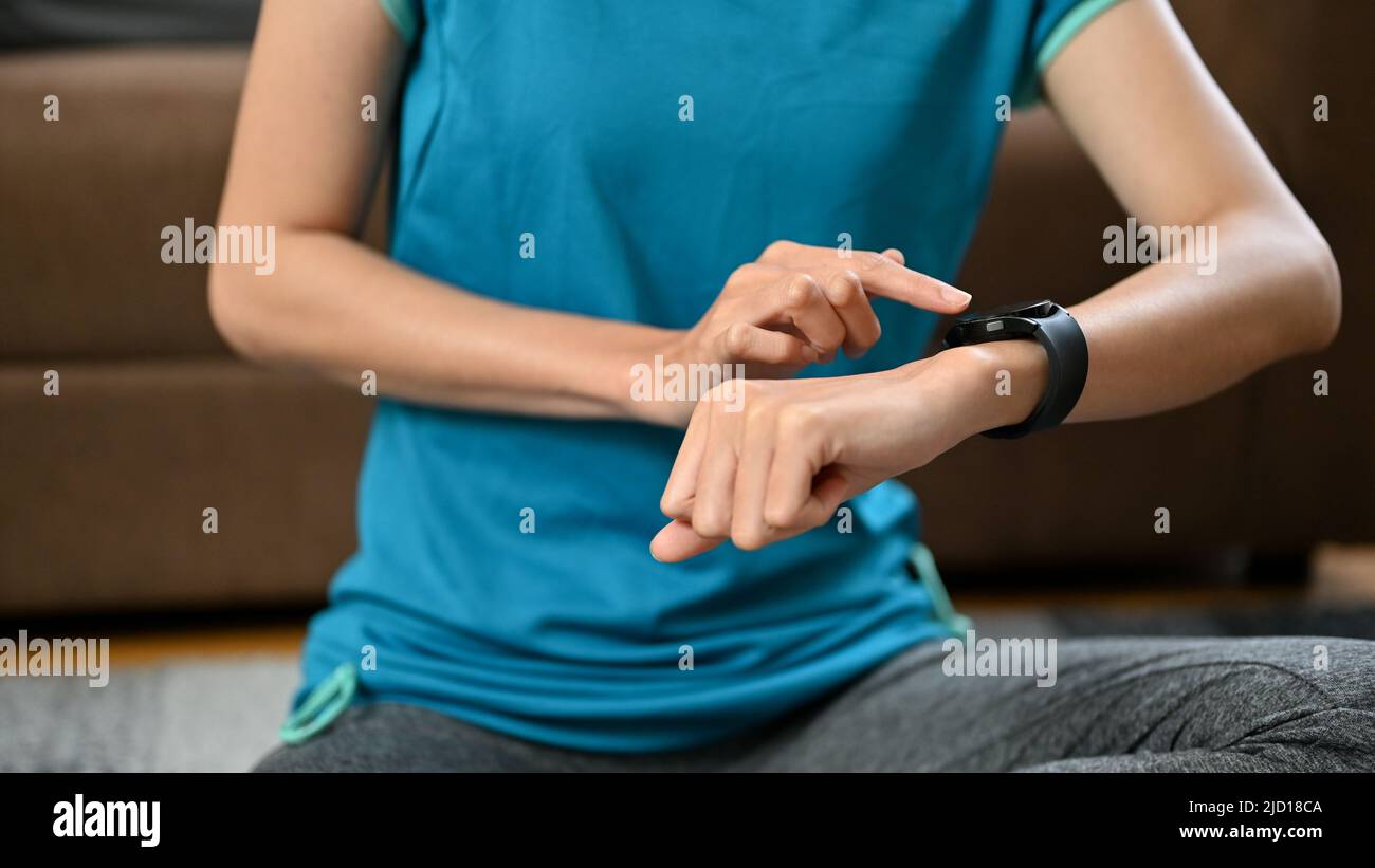 Female checking her heart rate and pulse on her modern smartwatch after ...