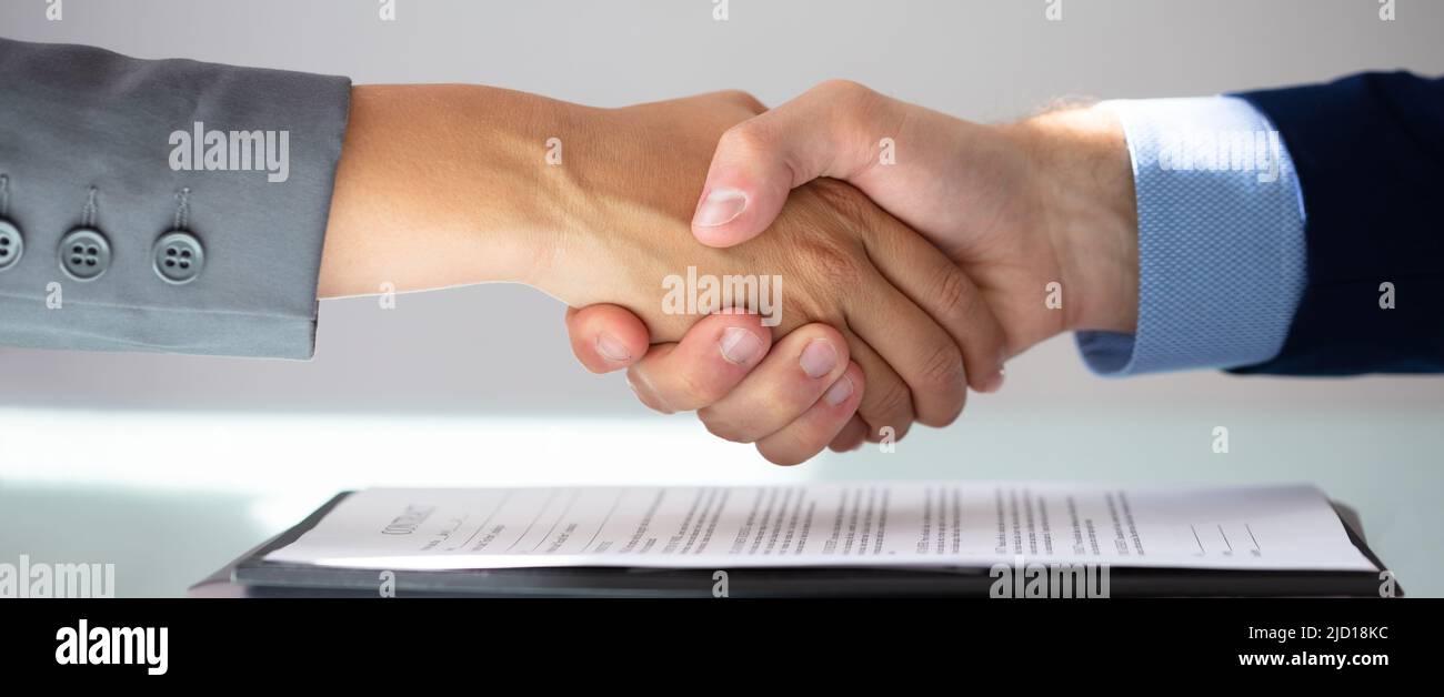 Business Partners Shaking Hands Over Contract Form Stock Photo - Alamy