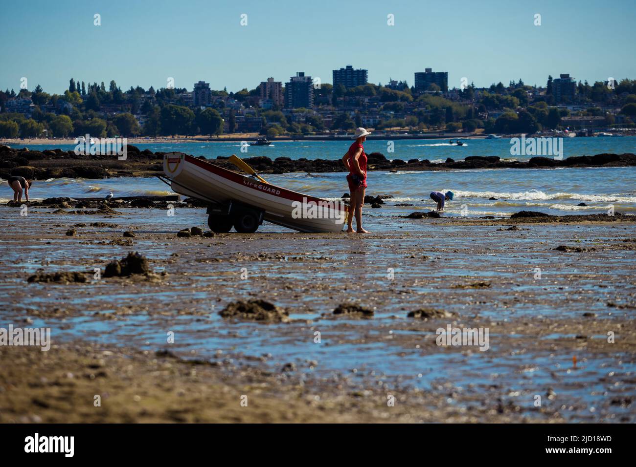 lifeguard at work. Lifeboat on the beach, lifeguard looks at the ocean ...