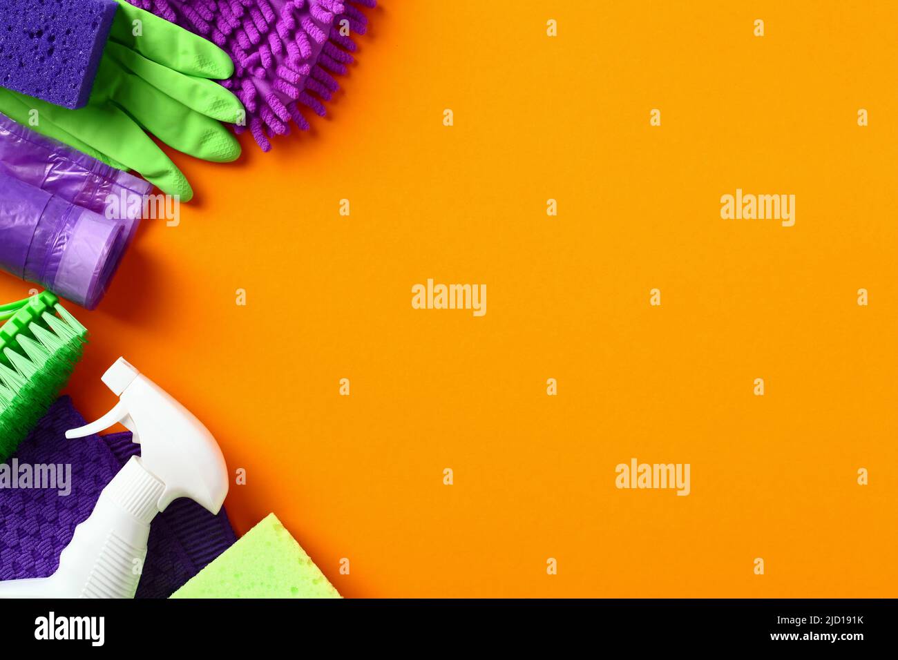 Cleaning products frame on orange background. Housekeeping and ...