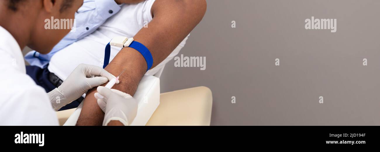 Close-up Of Female Doctor Injecting Male Patient With Syringe To ...
