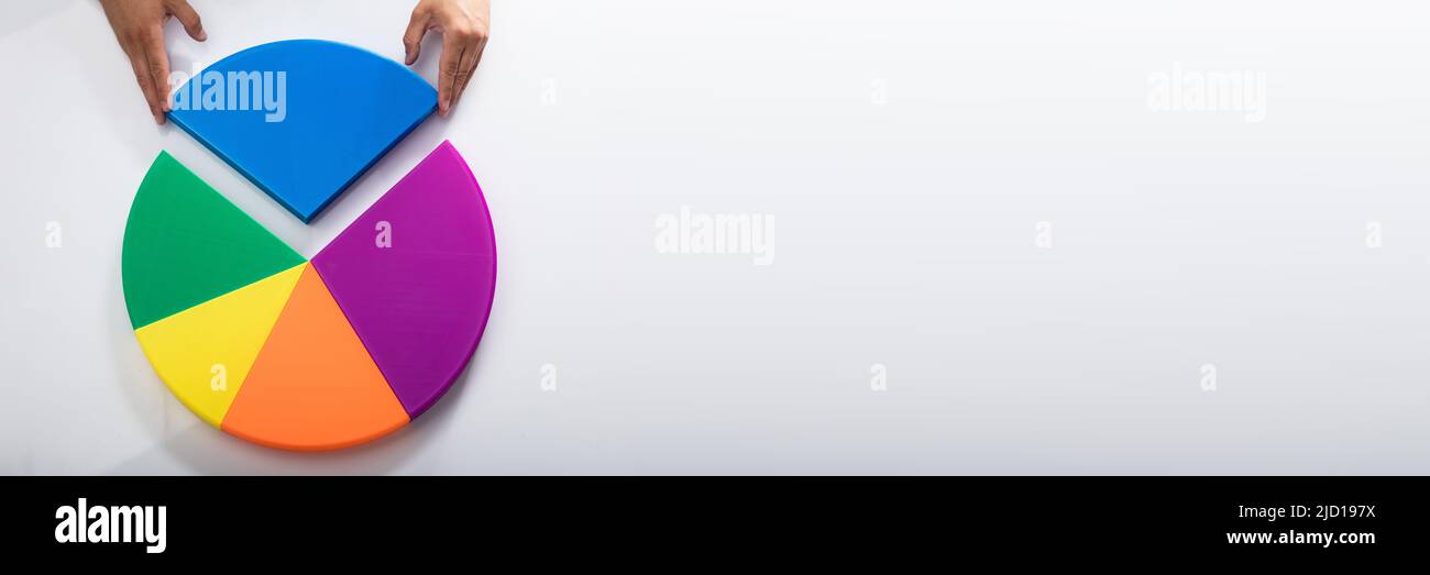 Human hand placing final blue piece into multi colored pie chart Stock ...