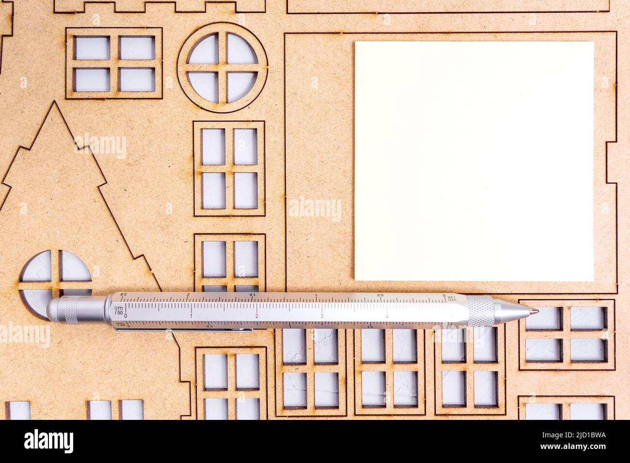 Wooden house model kit with paper note and ballpoint pen. Home ...