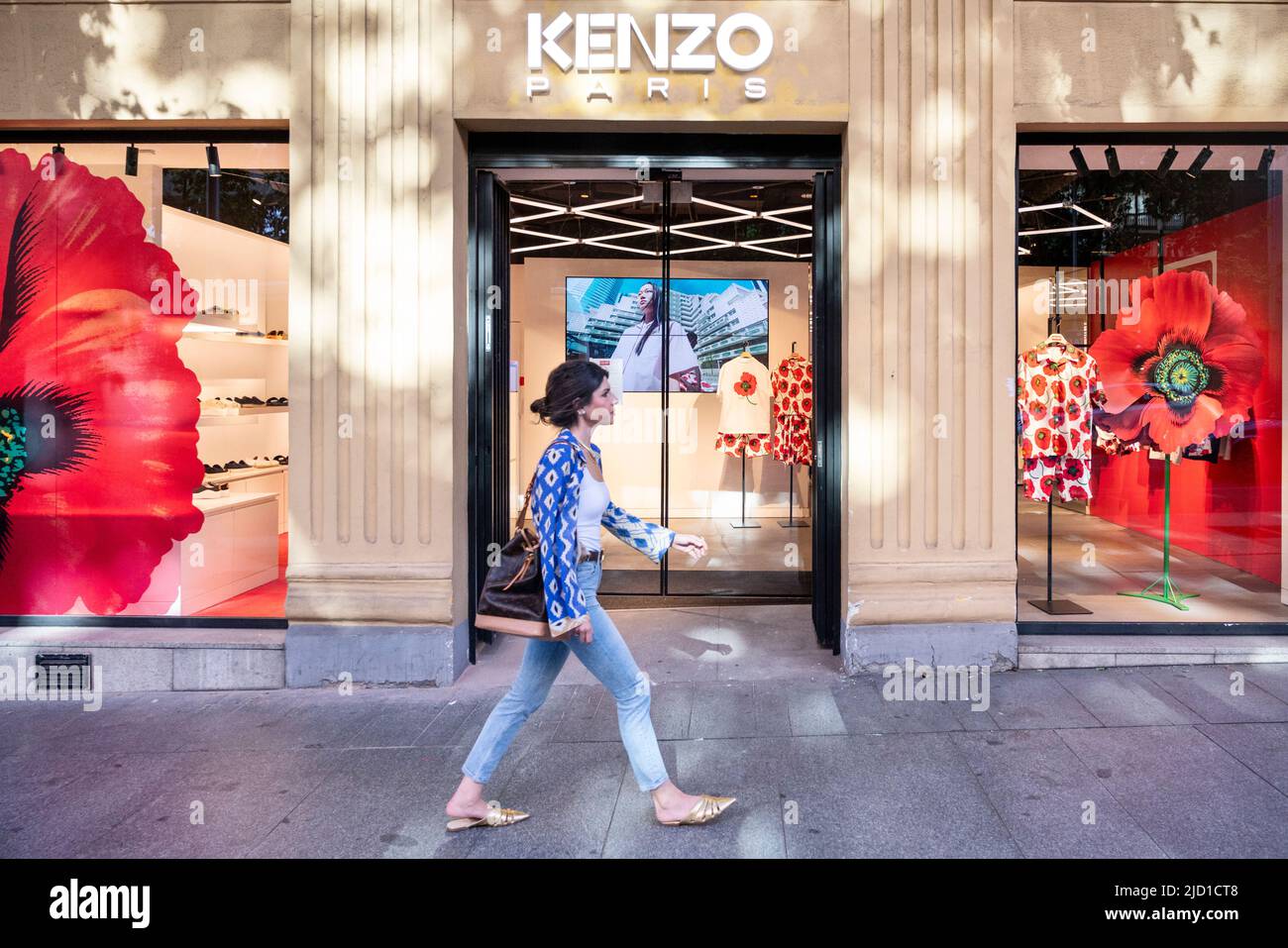 A woman walks past the French luxury fashion house owned by LVMH and ...