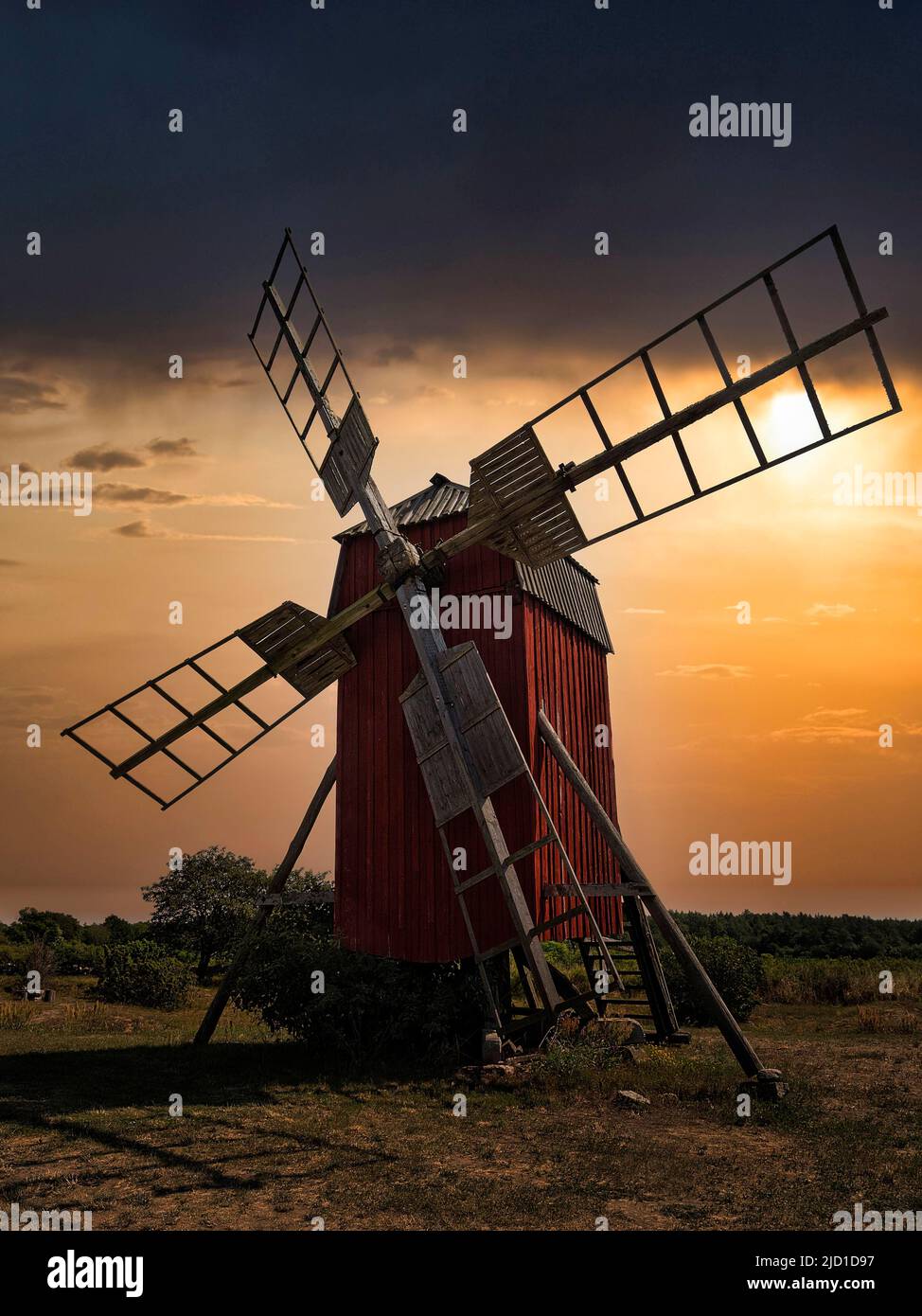 Backlit trestle windmill, dramatic evening sky, Lerkaka mills, Oeland ...