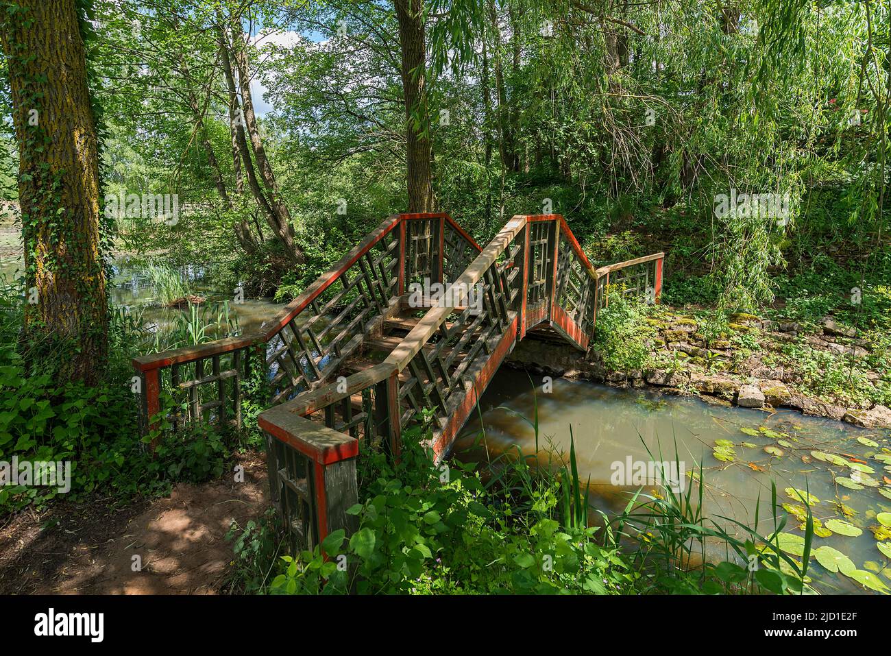 Curved wooden bridge in Dennenlohe Castle Park Middle Franconia ...