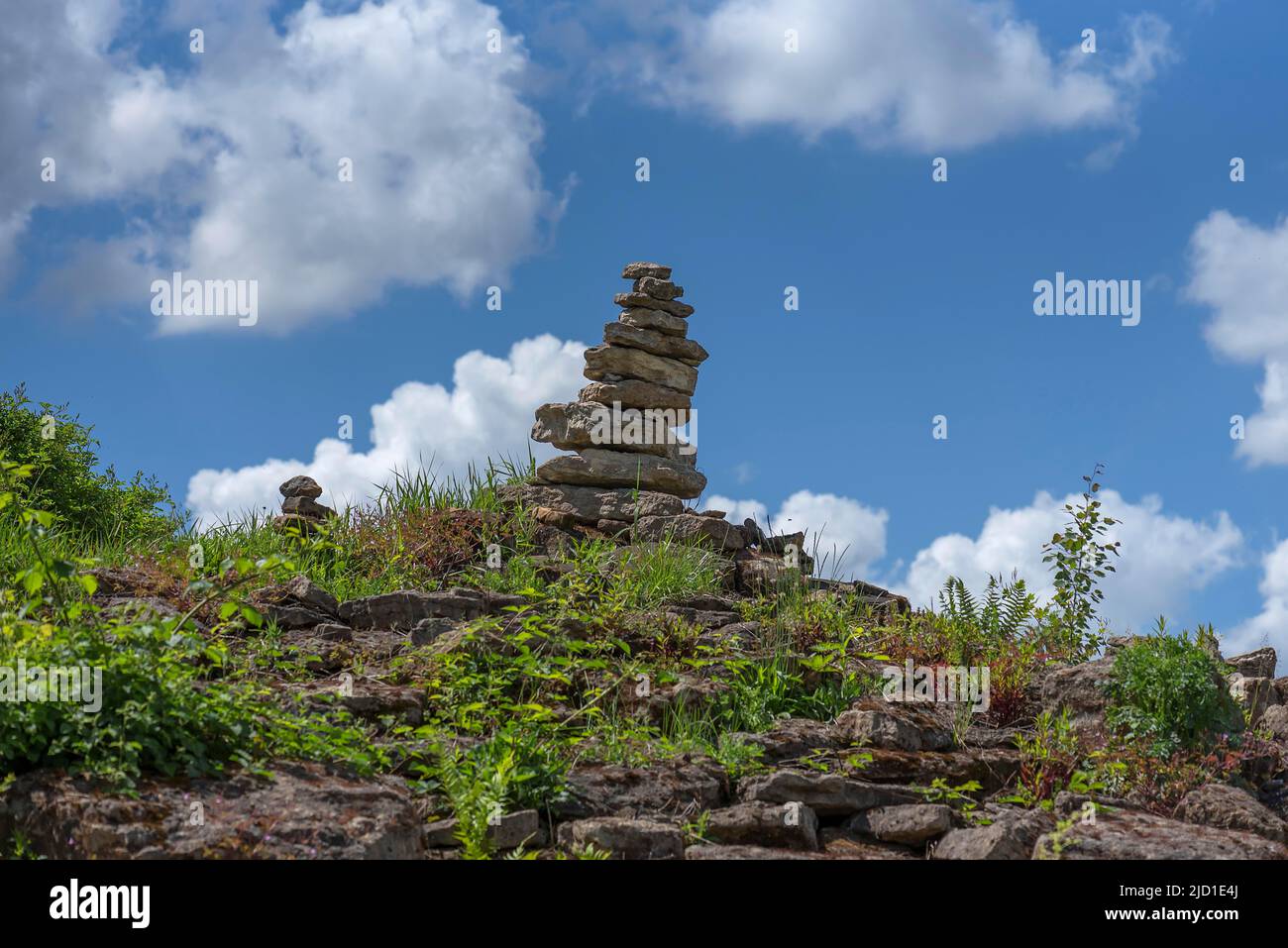 Stones stacked on top of each other, cairns with cloudy sky, Dennenlohe ...