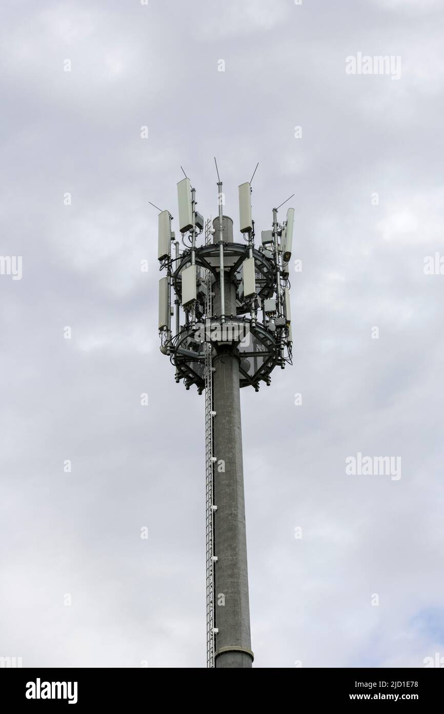 Mobile phone mast, transmission mast in front of dark cloudy sky ...
