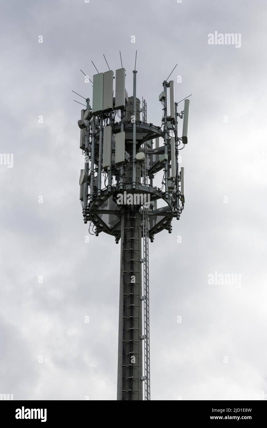Mobile phone mast, transmission mast in front of dark cloudy sky ...