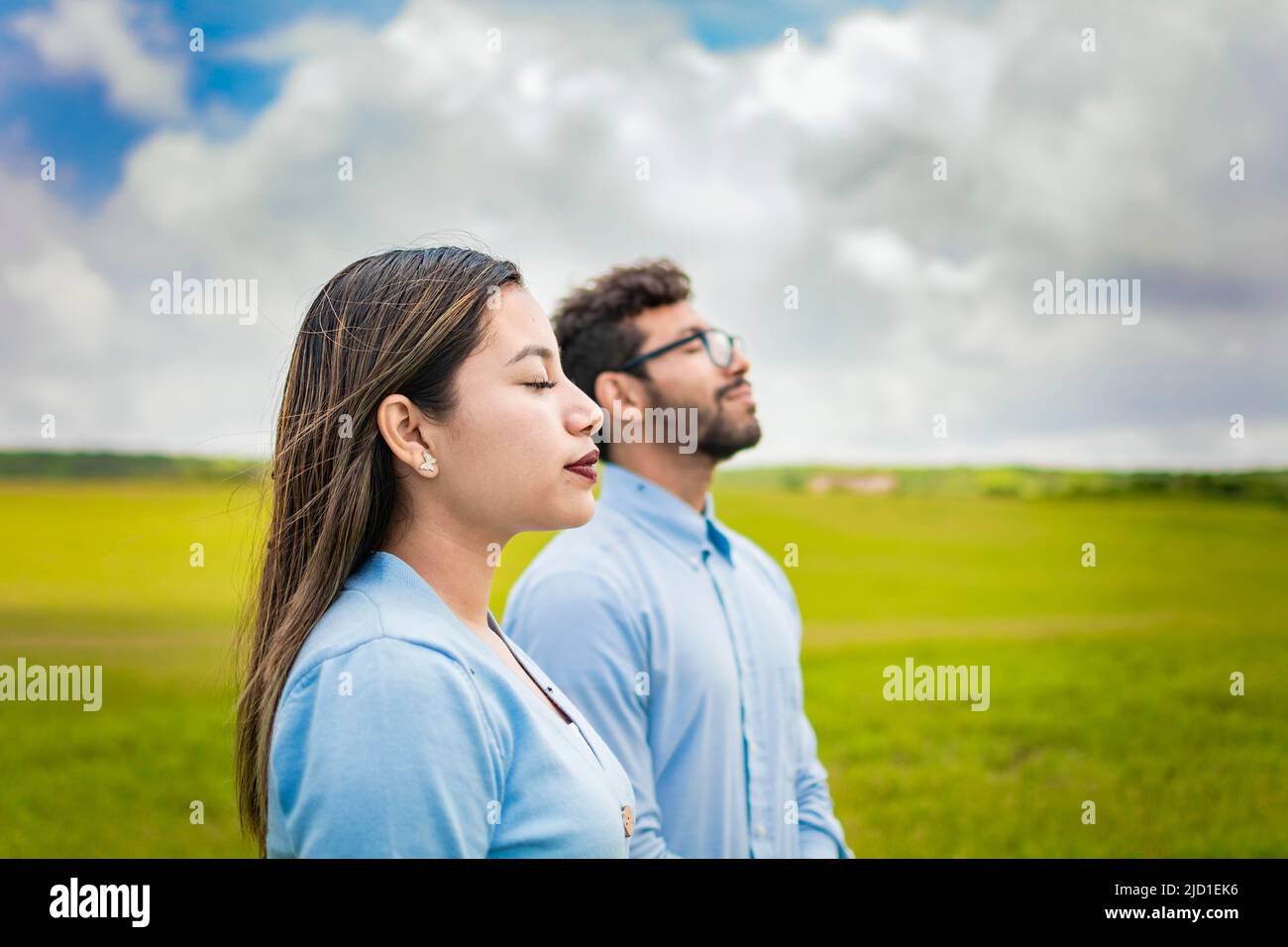 Two people breathing fresh air in the field, Young couple breathing ...