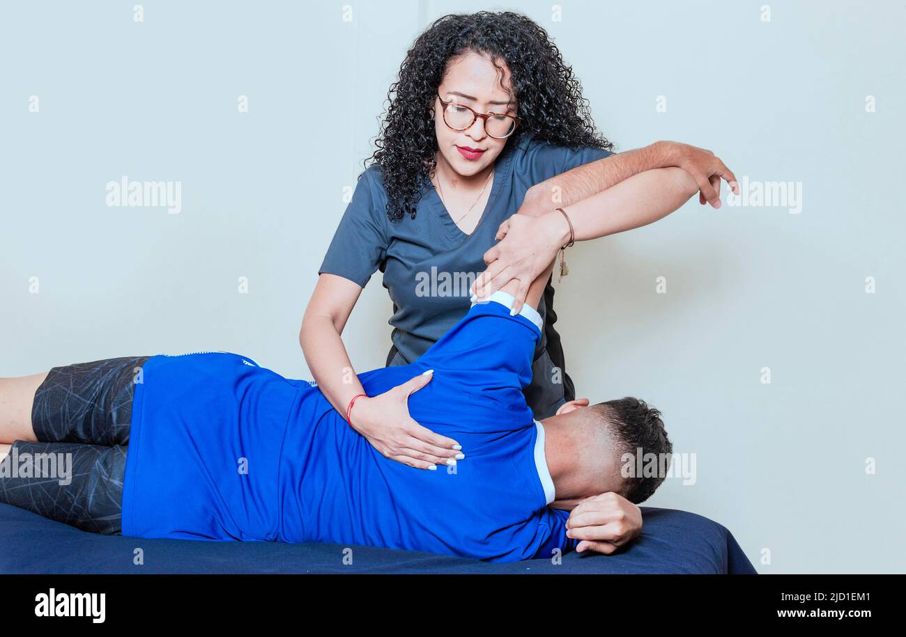 Female doctor with patient undergoing back treatment, Back ...