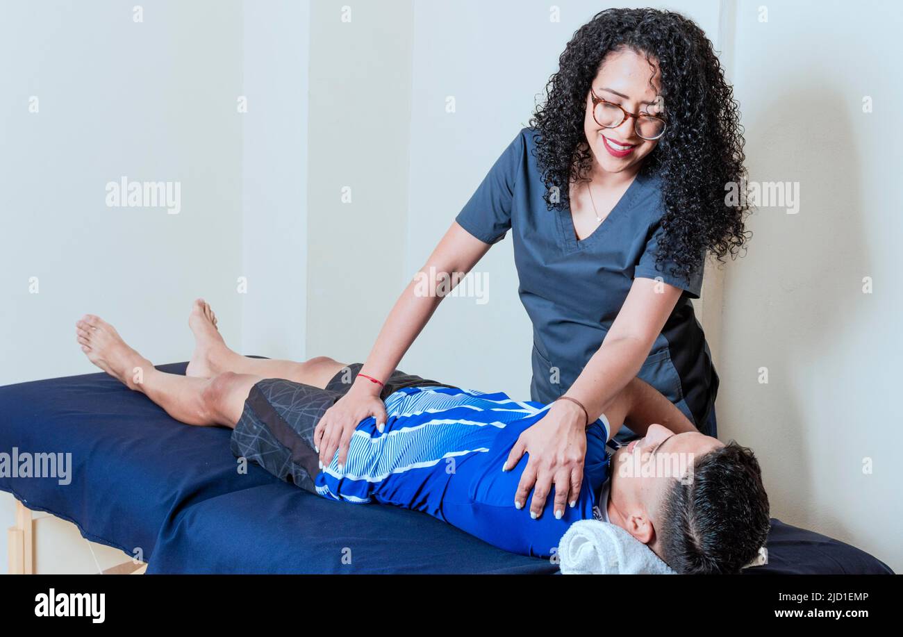 Female doctor with patient undergoing back treatment, Back ...