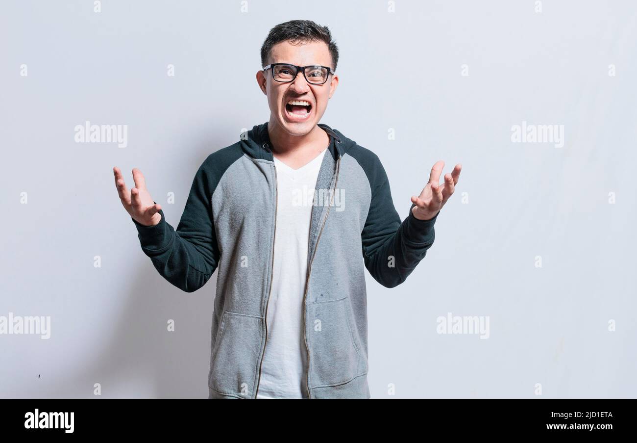 Young man with open hands screaming angry to the camera, Irritated ...